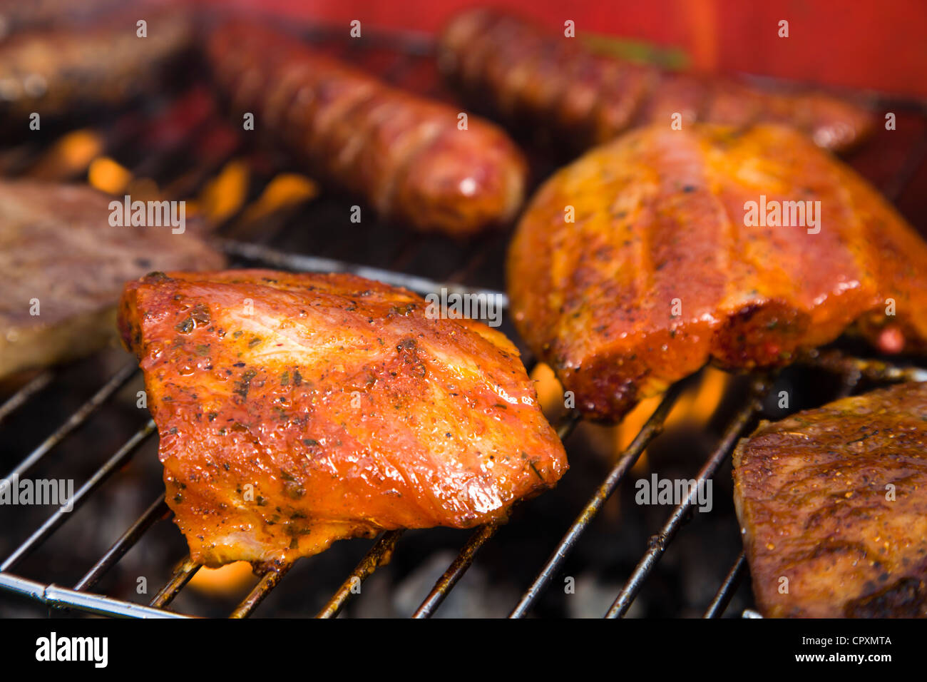 Closeup of fried meat on grill Stock Photo - Alamy