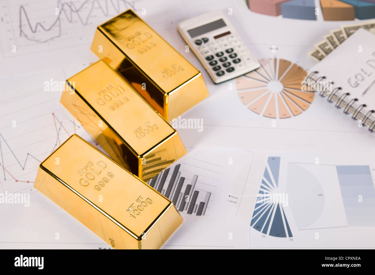 Gold bars on graphs and statistics Stock Photo - Alamy