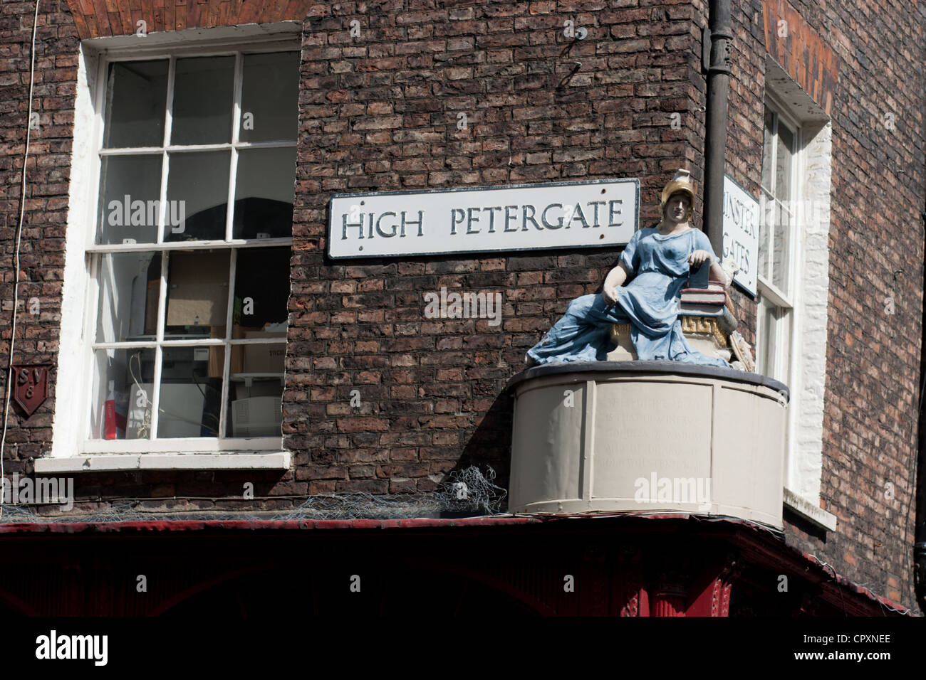 A close up of a statue above the street at High Petergate in York Stock ...
