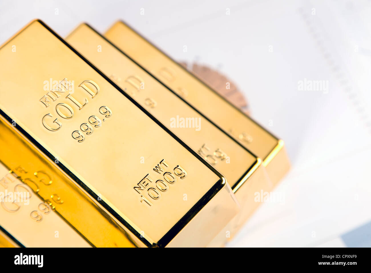 Gold bars on graphs and statistics Stock Photo - Alamy