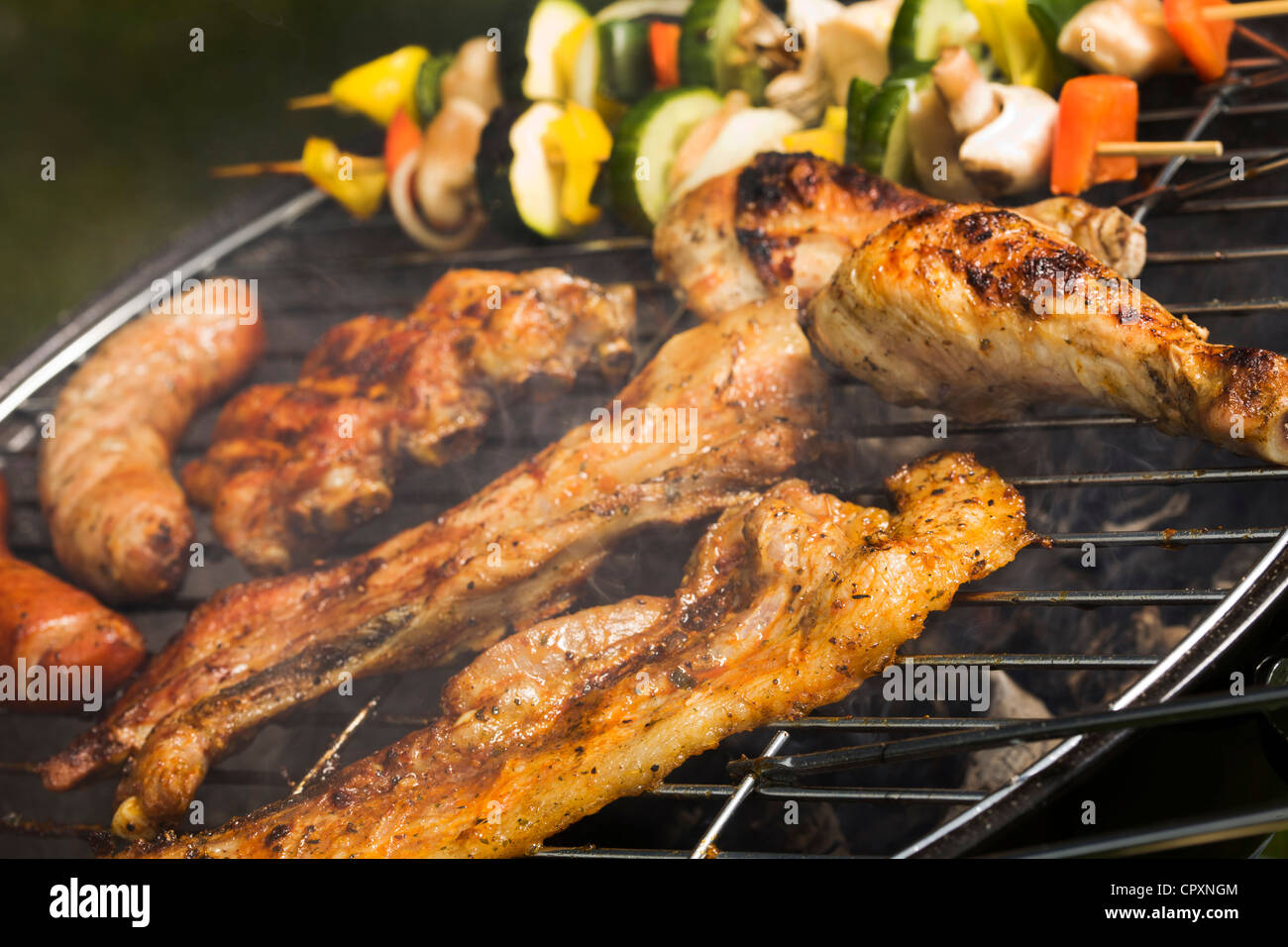 Closeup of fried meat on grill Stock Photo - Alamy