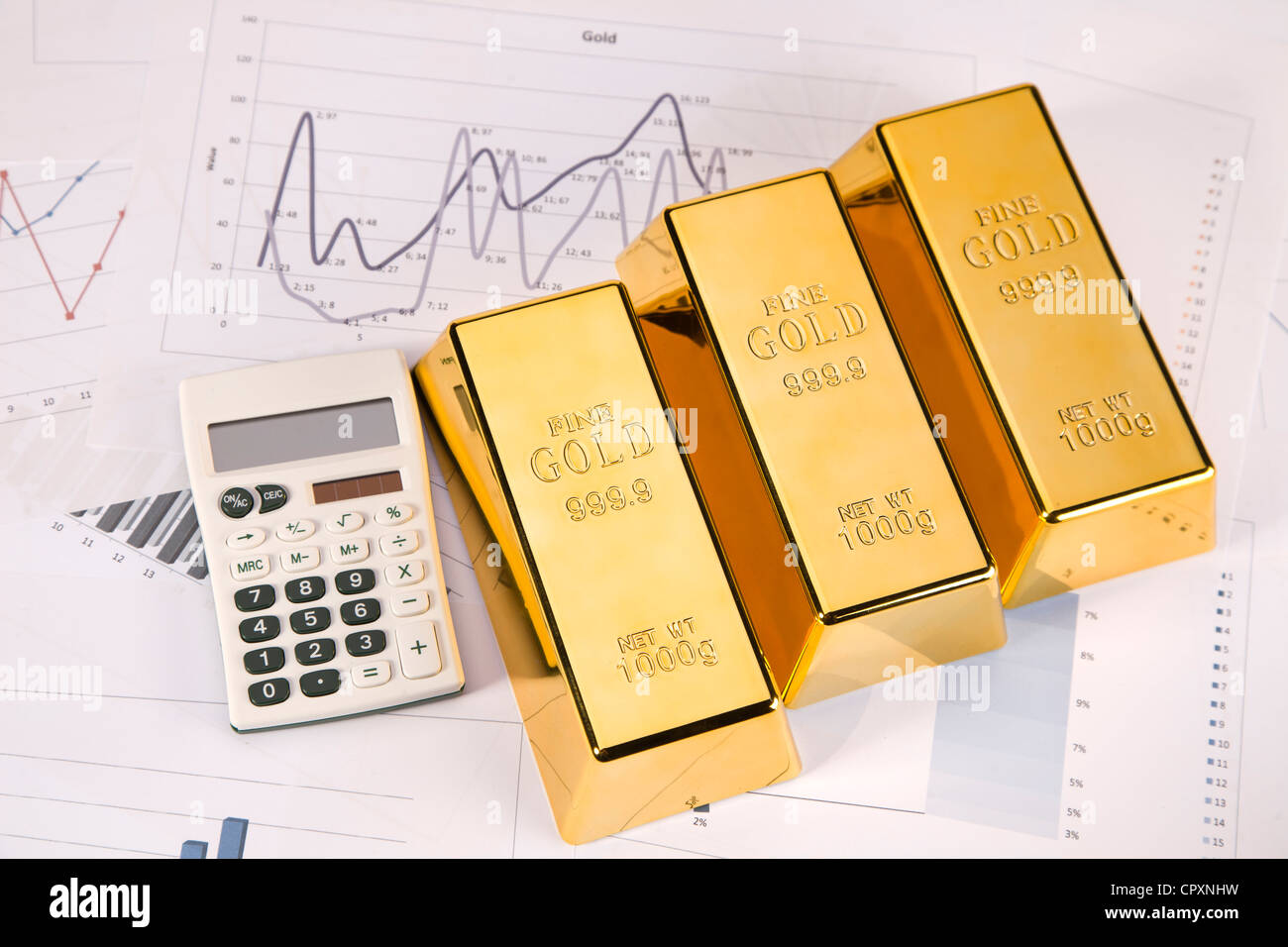 Gold bars on graphs and statistics Stock Photo - Alamy