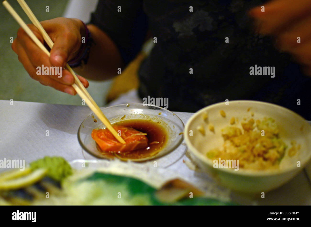 Eating Sushi and Sashimi in japanese restaurant Stock Photo - Alamy