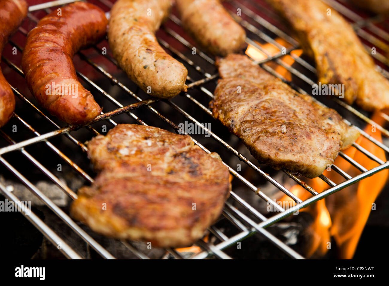 Closeup of fried meat on grill Stock Photo - Alamy