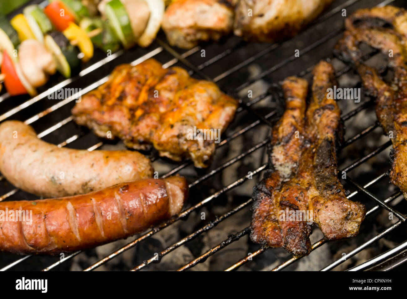 Closeup of fried meat on grill Stock Photo - Alamy