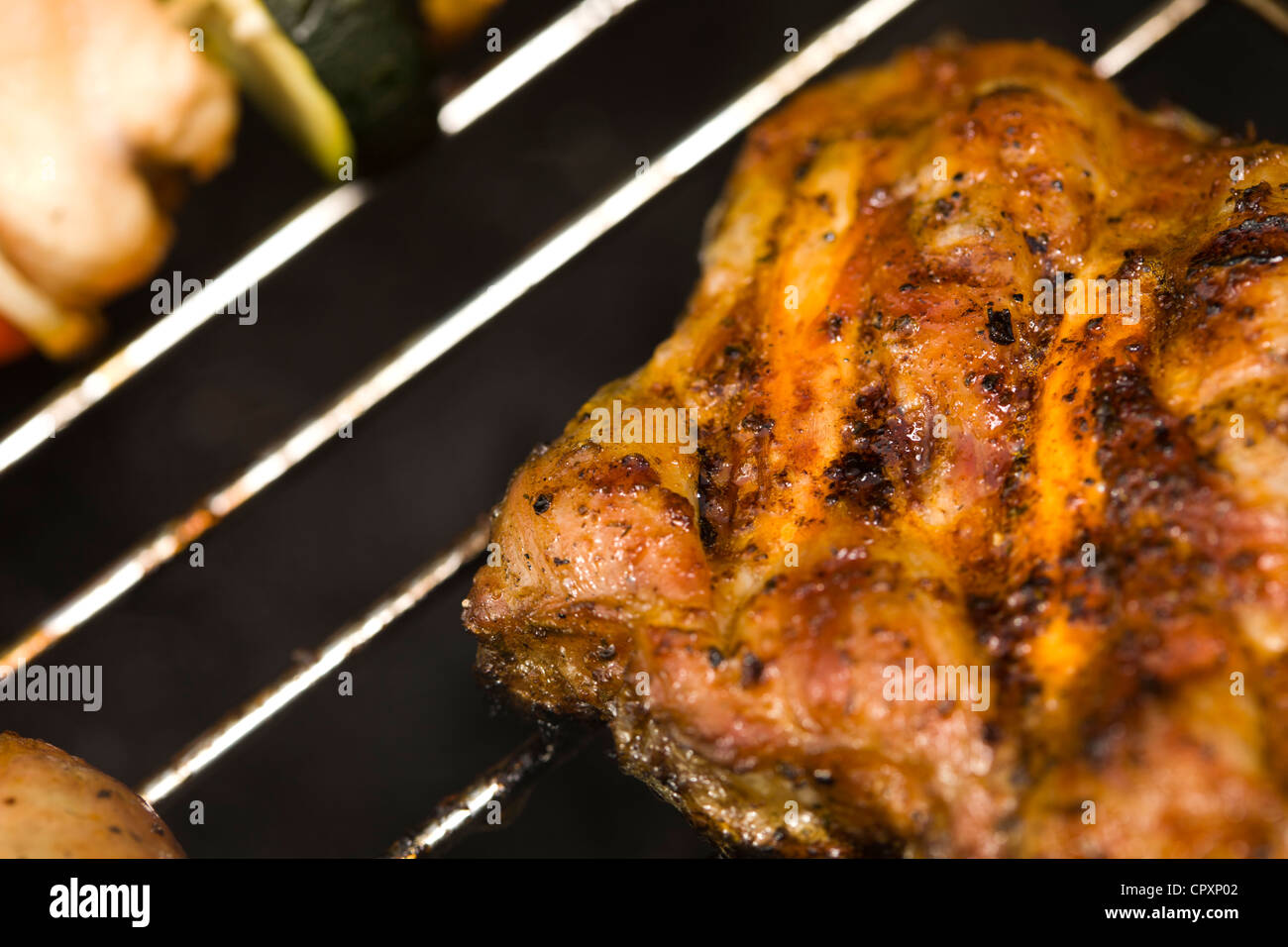 Closeup of fried meat on grill Stock Photo - Alamy