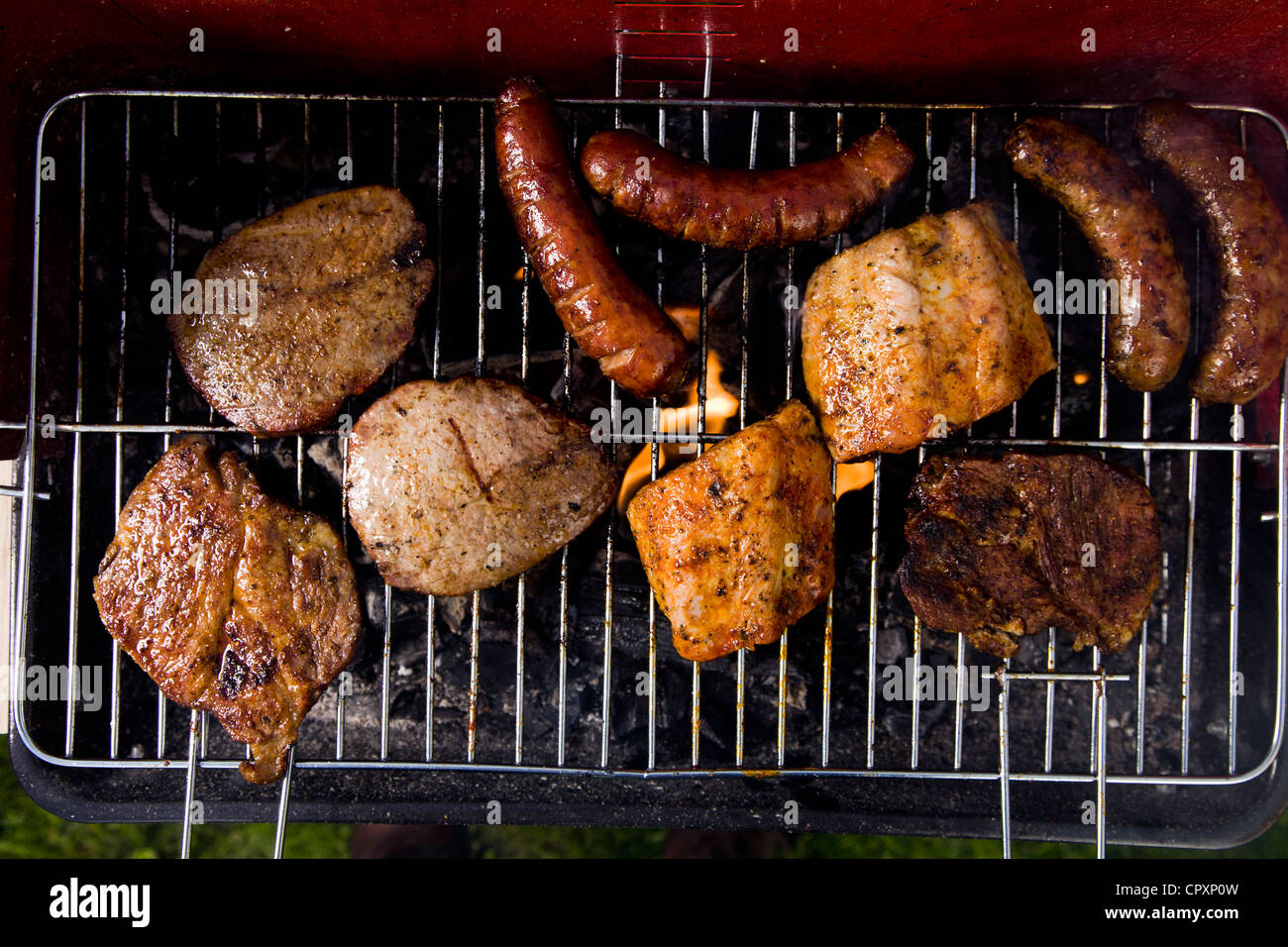 Closeup of fried meat on grill Stock Photo - Alamy
