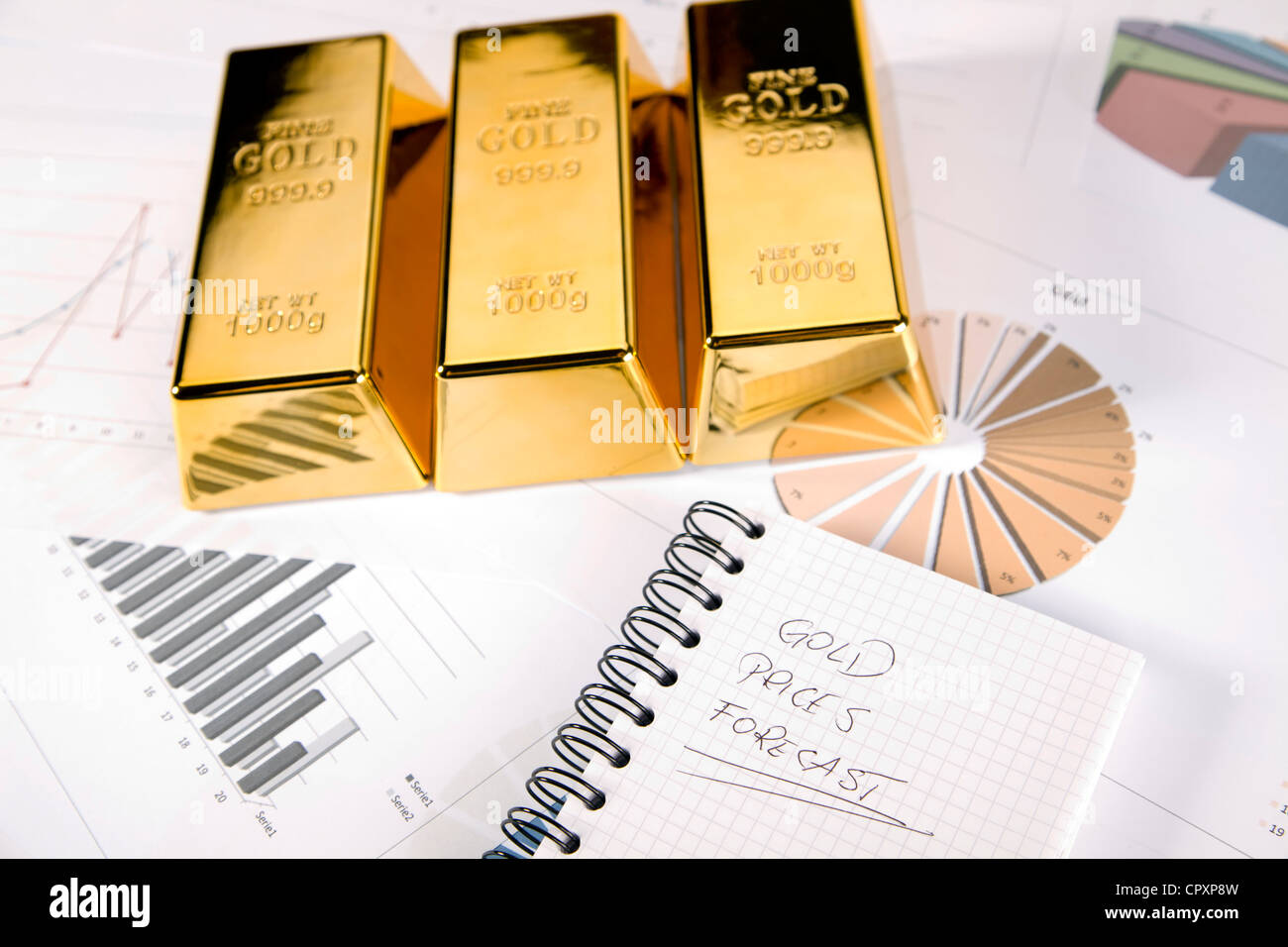 Gold bars on graphs and statistics Stock Photo - Alamy