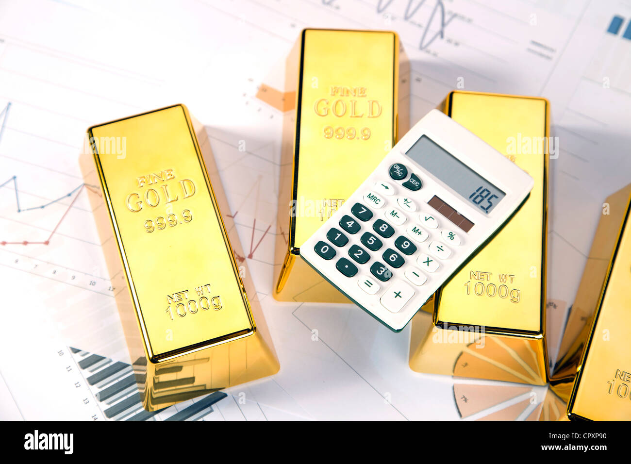 Gold bars on graphs and statistics Stock Photo - Alamy