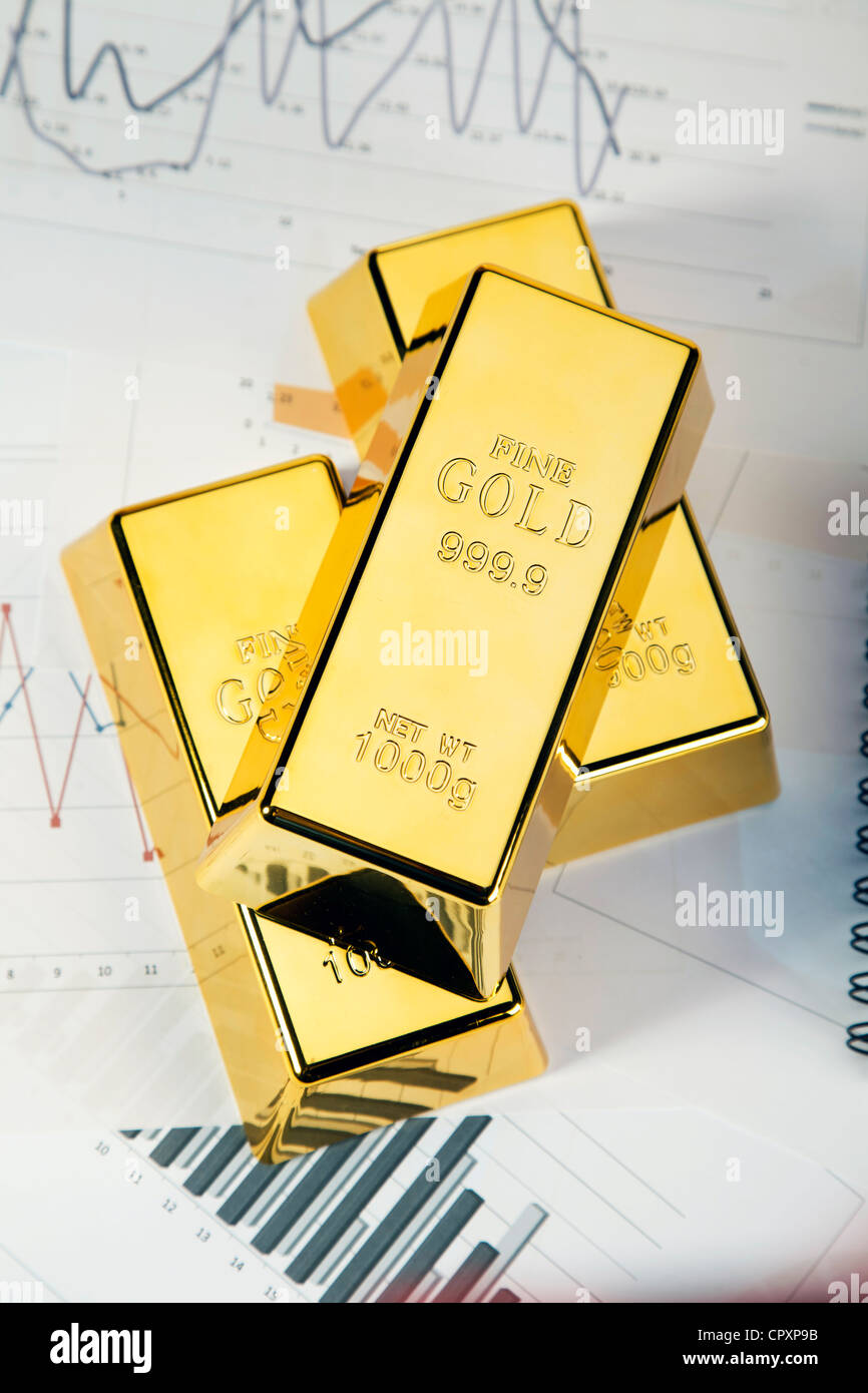 Gold bars on graphs and statistics Stock Photo - Alamy