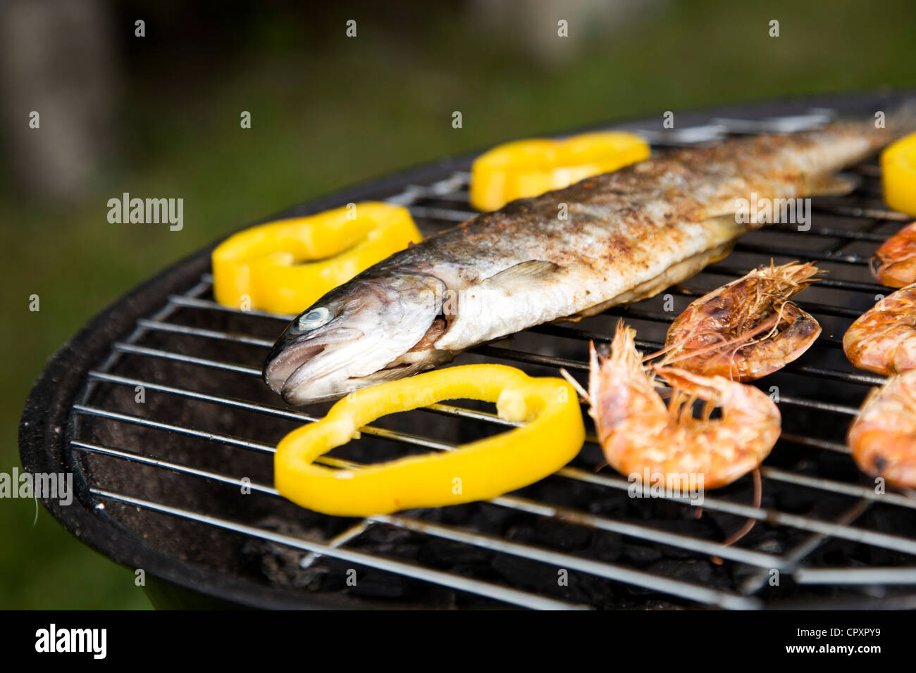 Seafood on grill. Fish and shrimps Stock Photo - Alamy