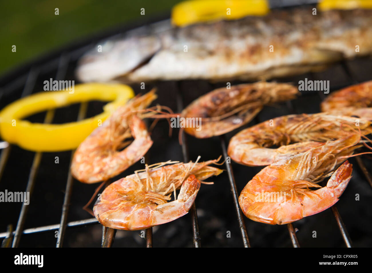 Seafood on grill. Fish and shrimps Stock Photo - Alamy