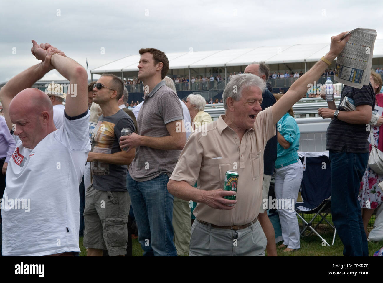 Emotions at the races. Punters horse racing the winner comes in the ...