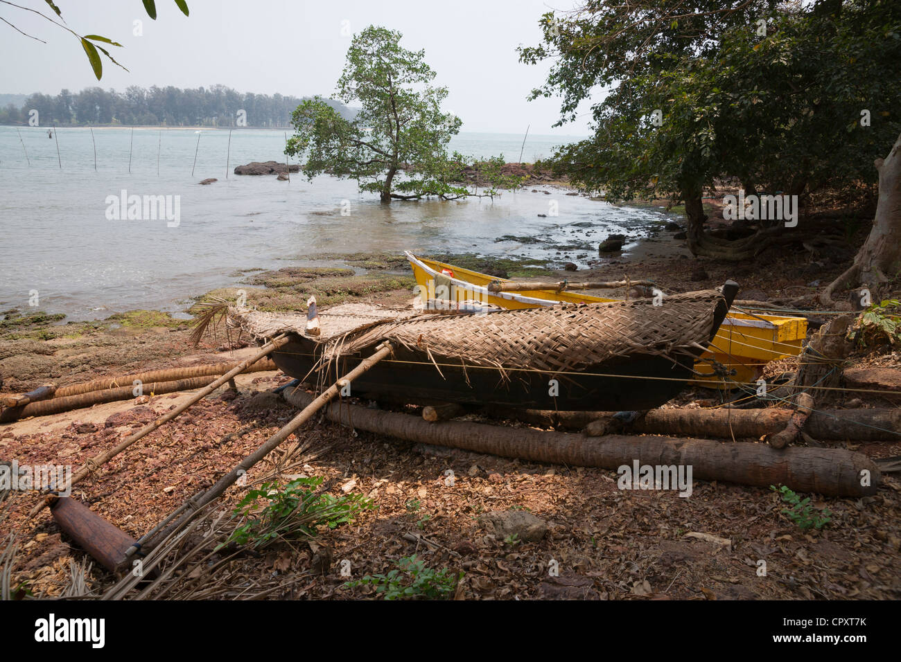 A traditional fishing boat with one outrigger on the beach in Tiracol ...