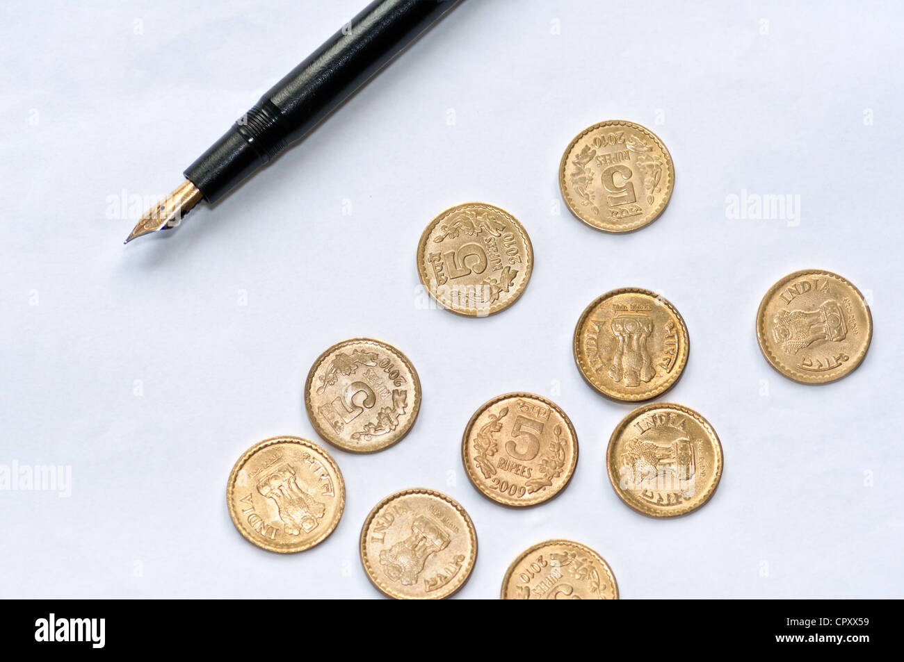 Closeup of accounting, sheet of blank white paper, pen and coins ...