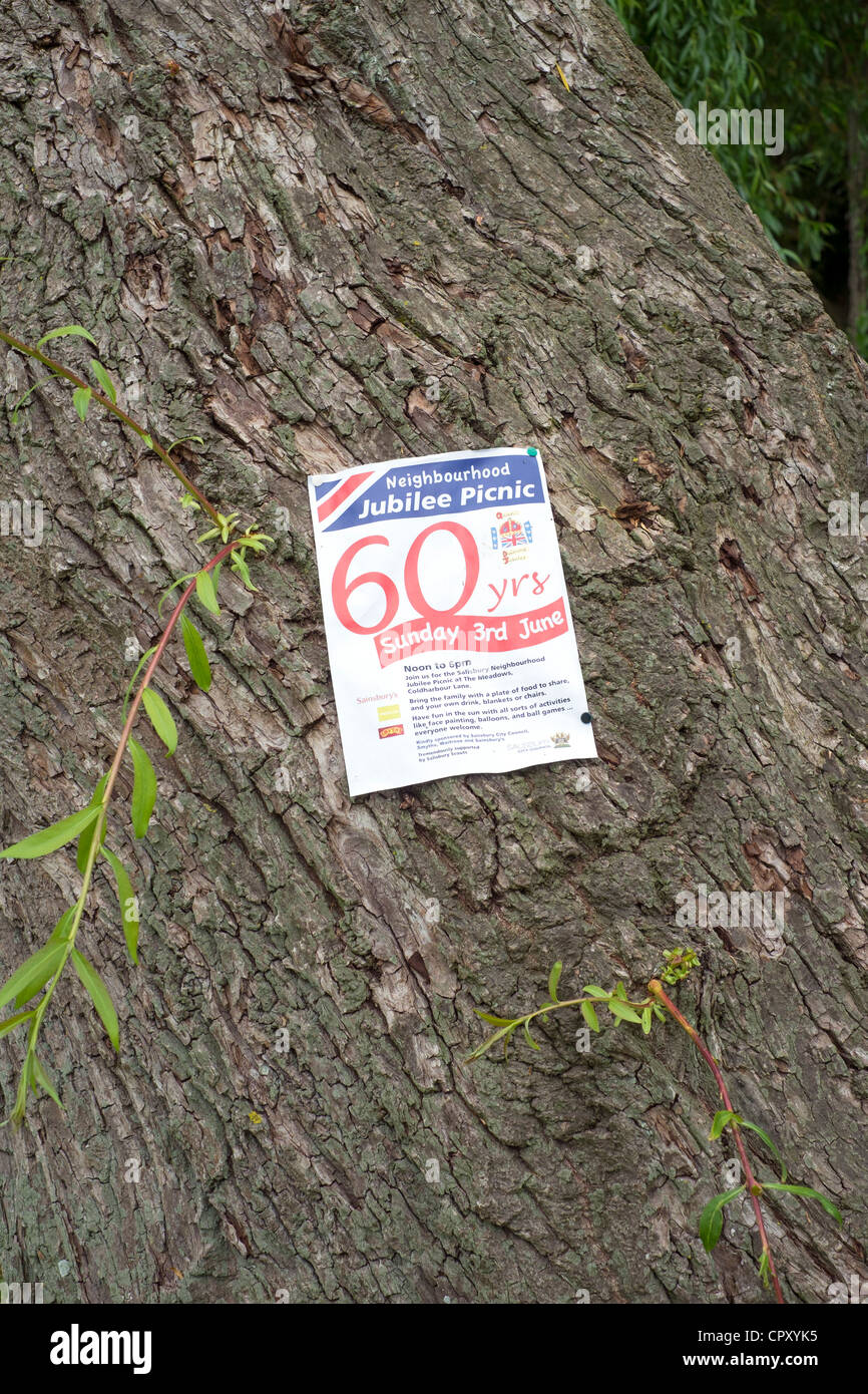 Poster pinned to a tree advertising an event to celebrate the Queens ...