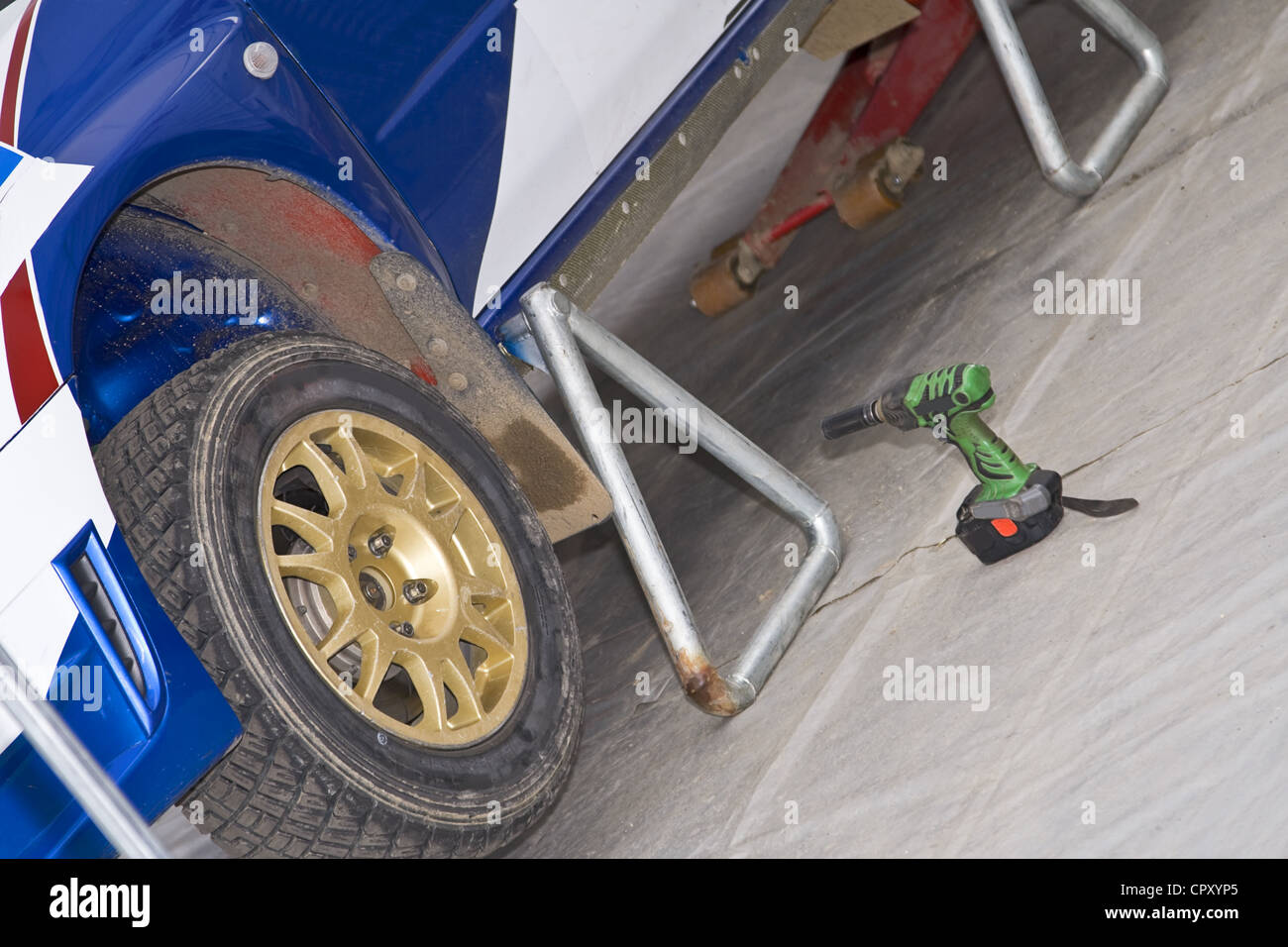 Detail of a rally car wheel and some tools at the pit stop Stock Photo ...