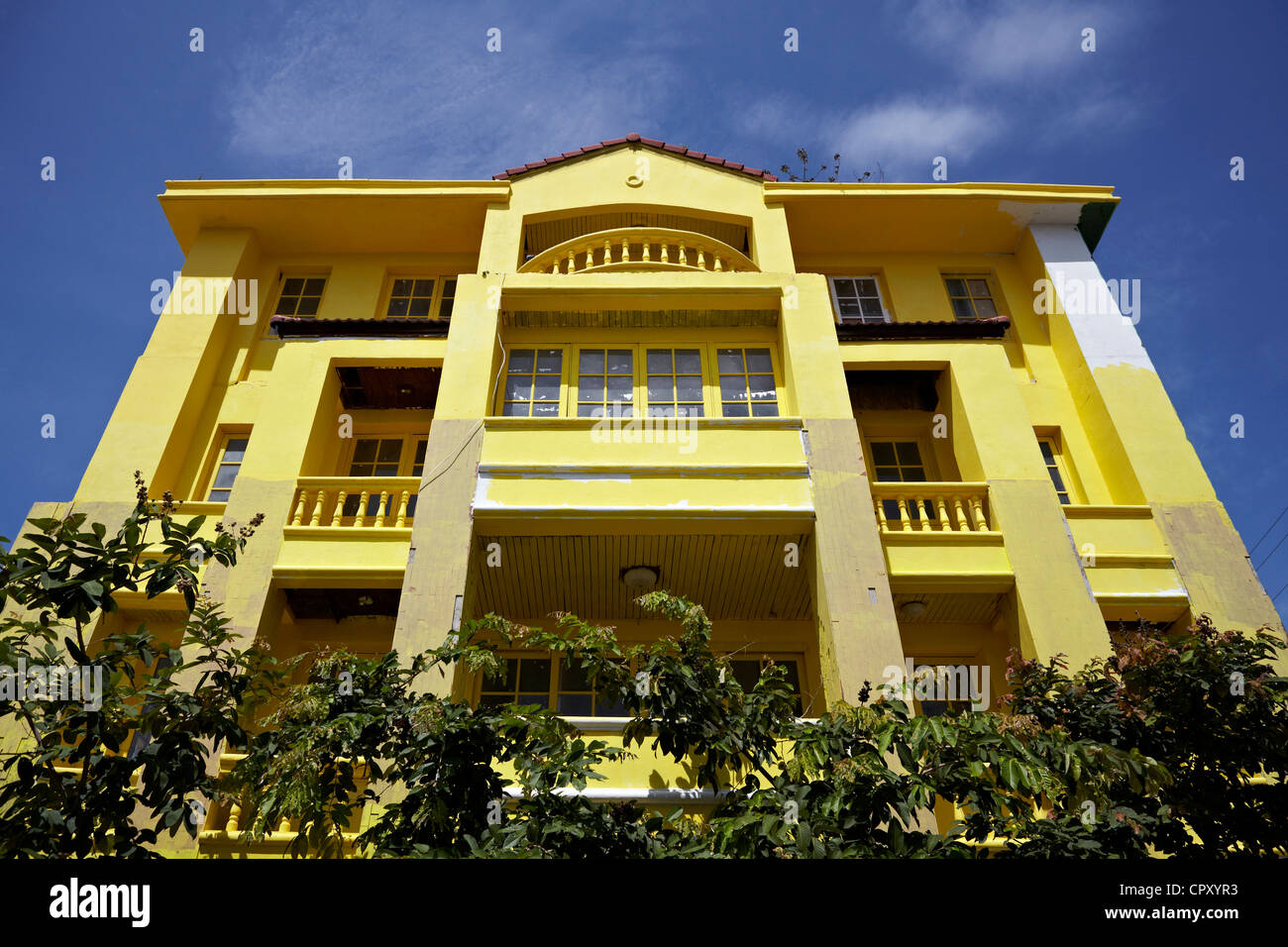 Yellow paint building. Bright yellow painted apartment block in the ...