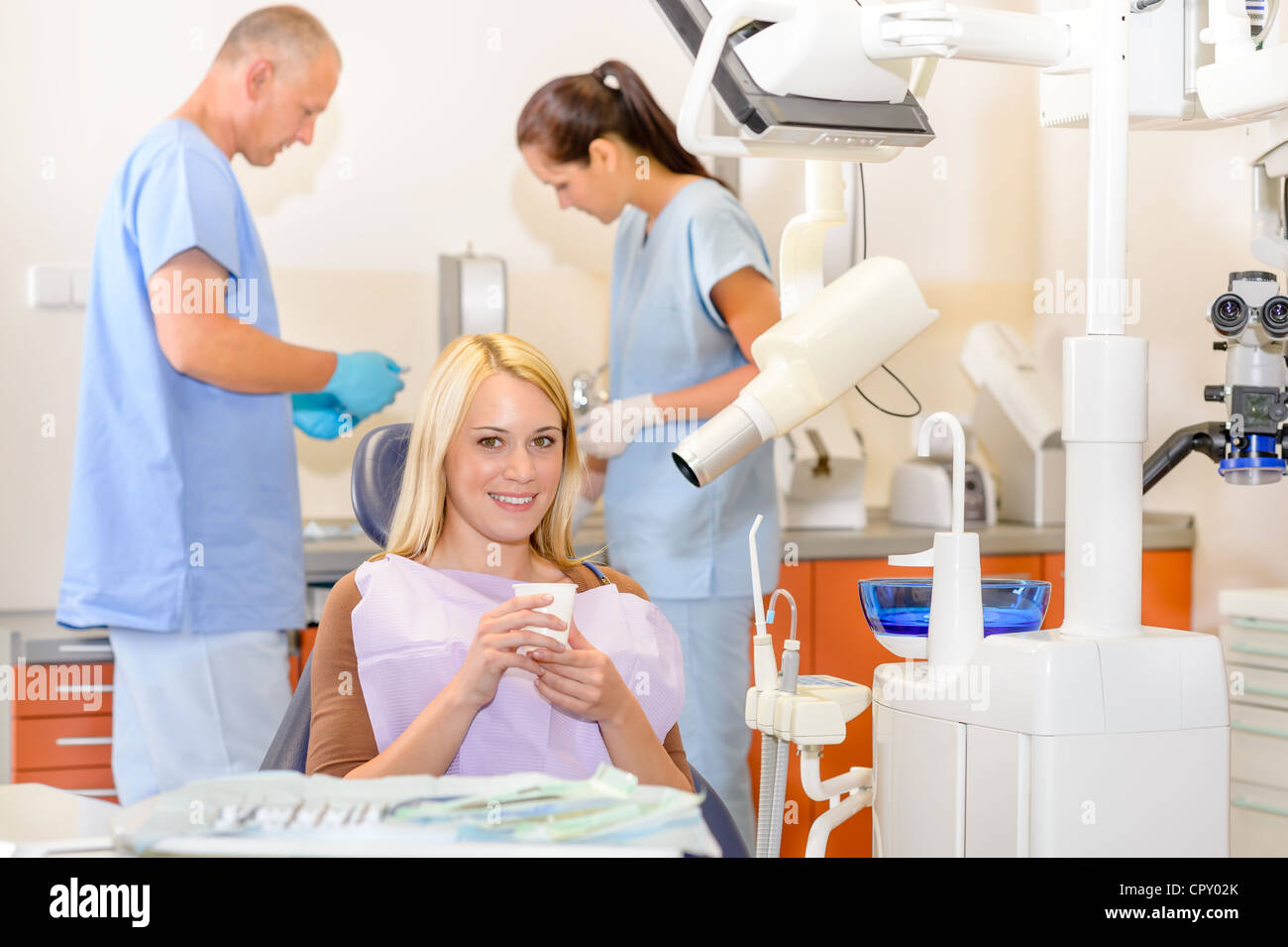 Smiling patient woman sitting at dentist surgery Stock Photo - Alamy