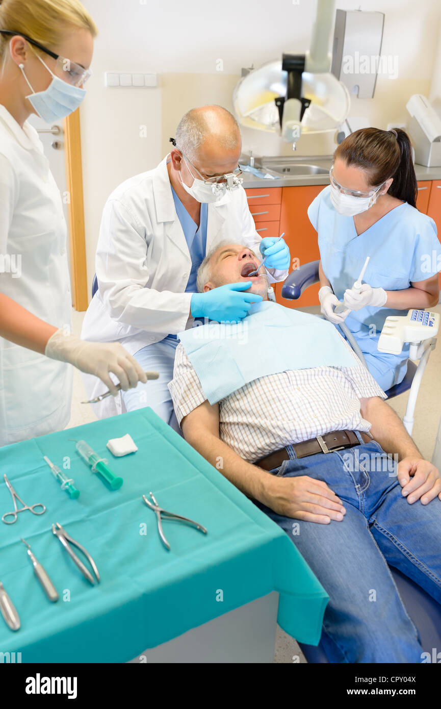 Senior man at dentist surgery having tooth operation stomatology clinic ...