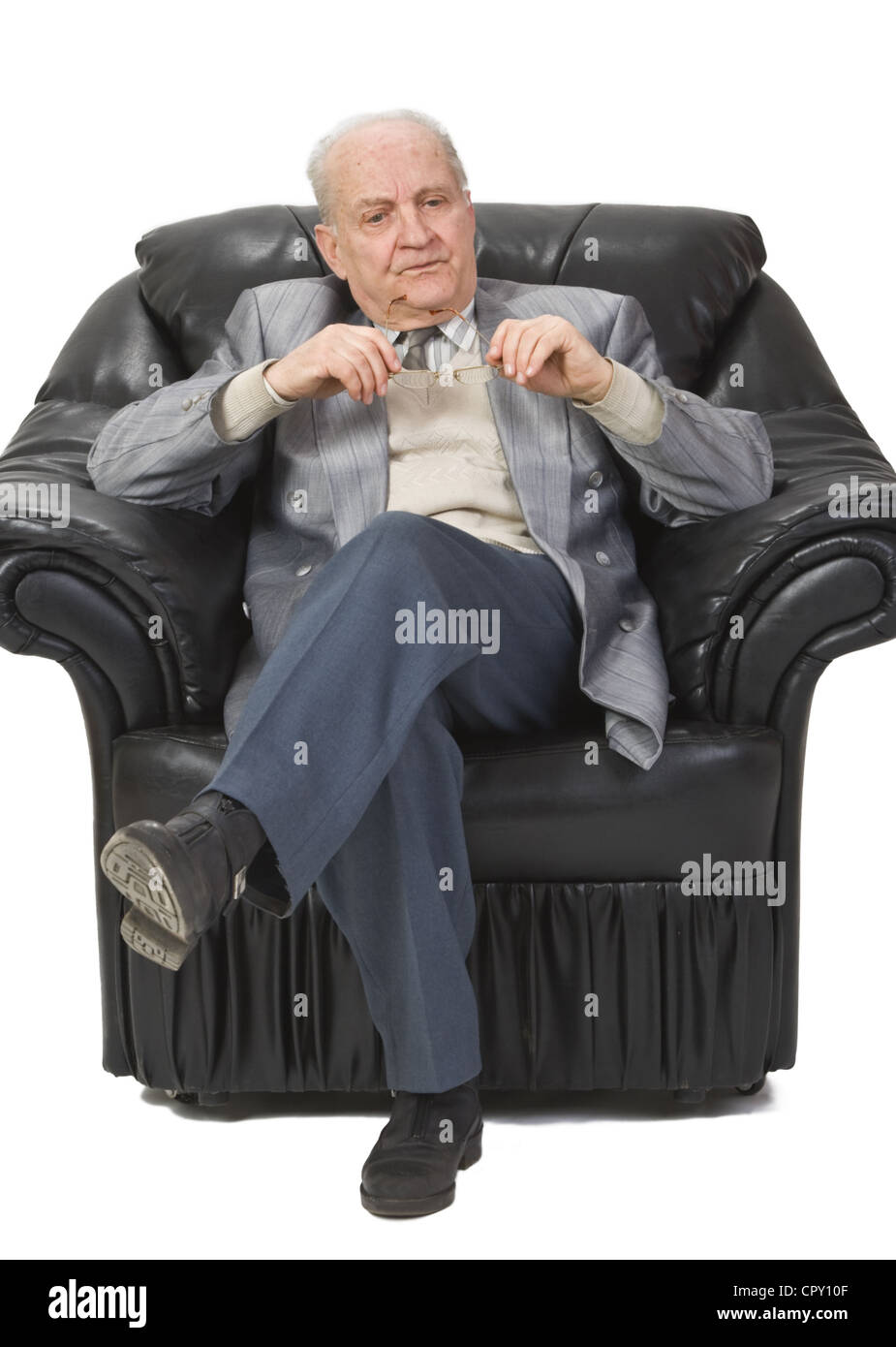 Portrait of a senior man sitting in an armchair and thinking deeply ...