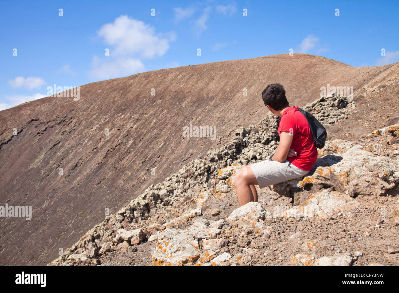 teenage boy resting, hike up the caldera of Bayuyo, volcano next to ...