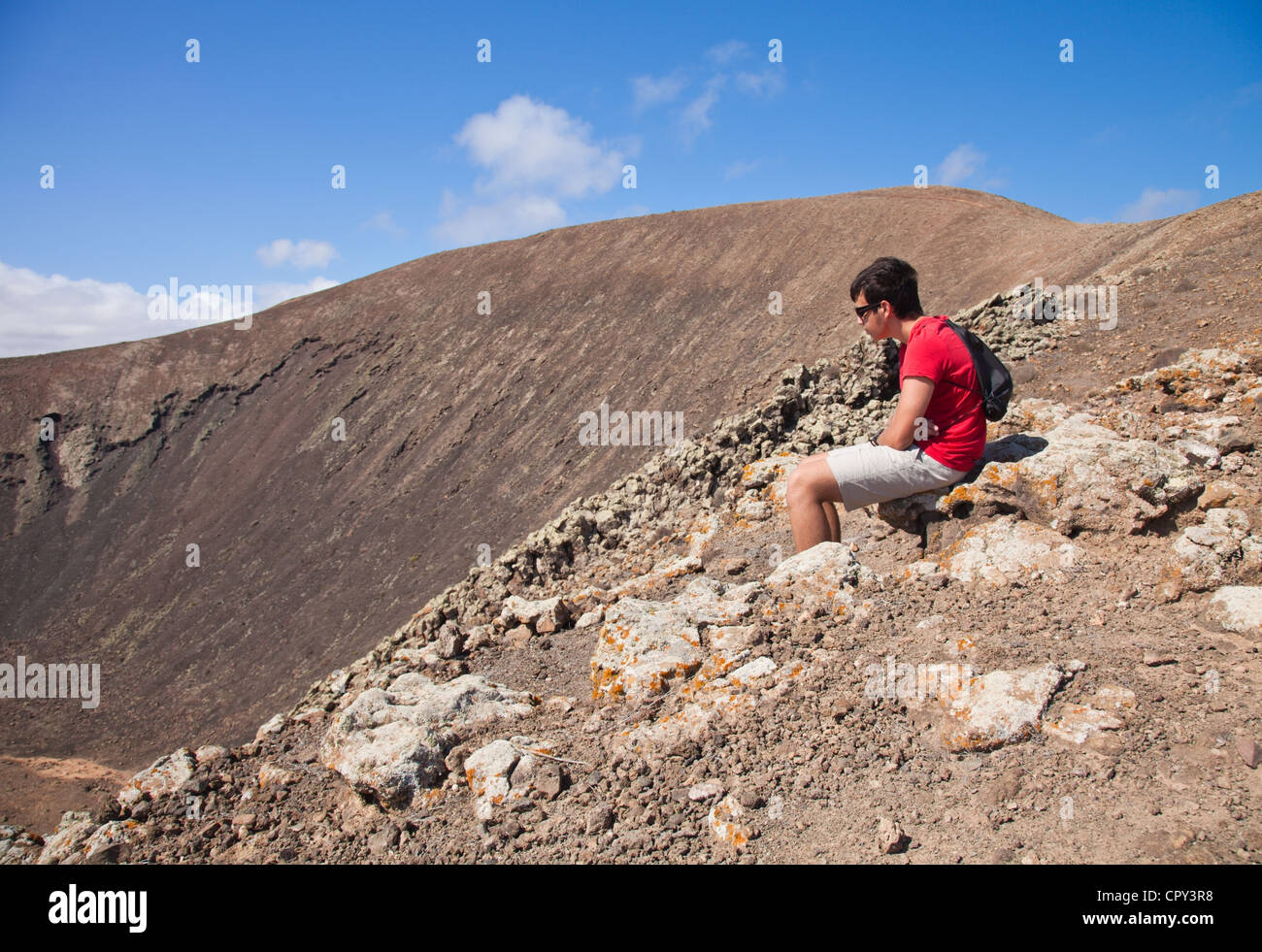 teenage boy resting, hike up the caldera of Bayuyo, volcano next to ...