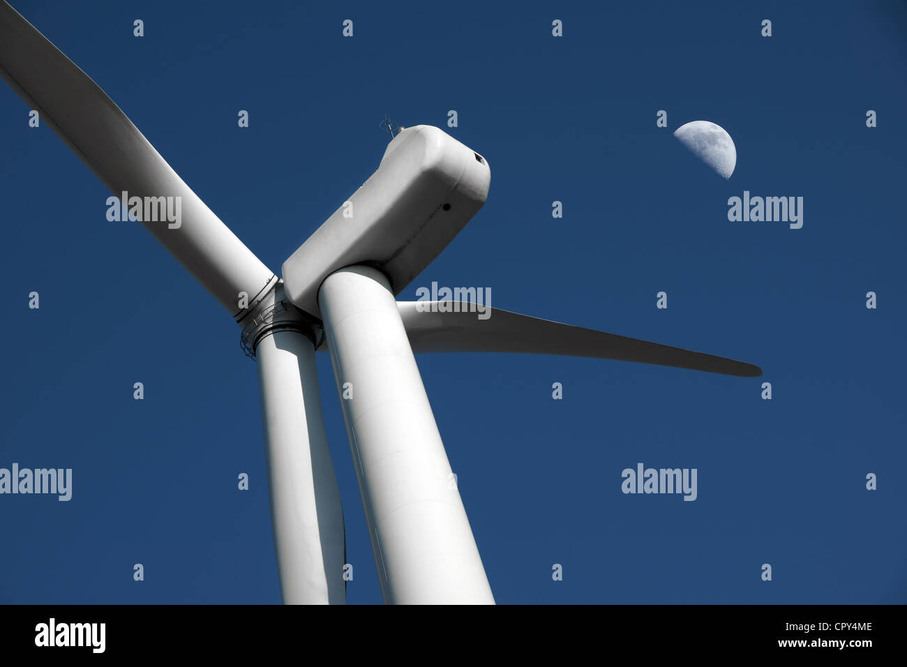 Wind turbine with half moon in background Stock Photo - Alamy