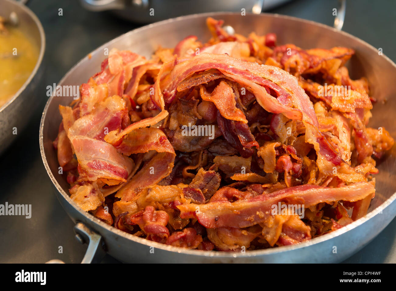 Skillet with cooked bacon for breakfast Stock Photo - Alamy