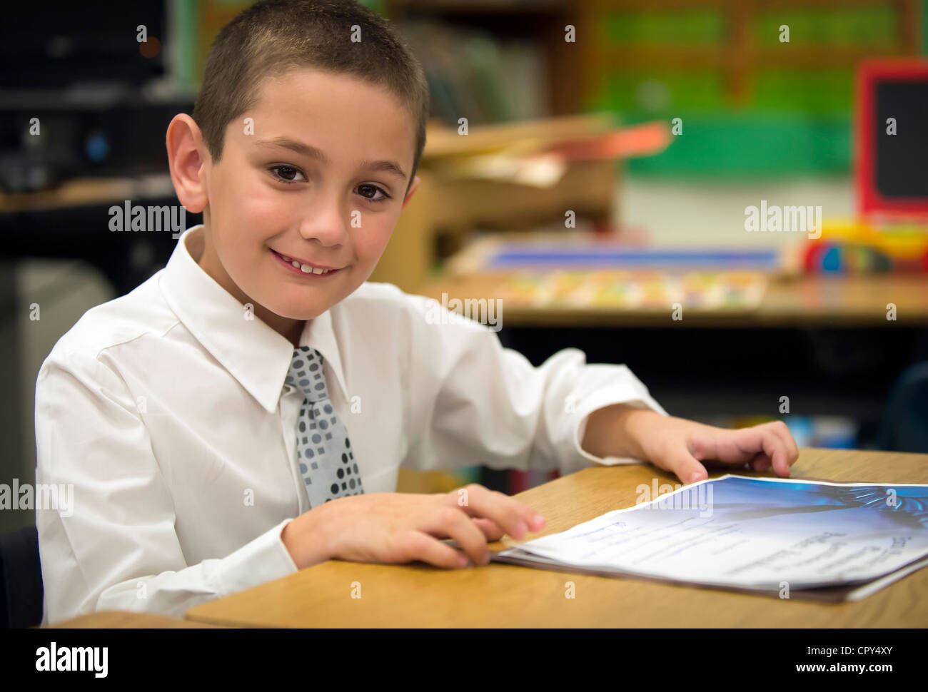 6 year old caucasian boy in a classroom smiling happy Stock Photo - Alamy