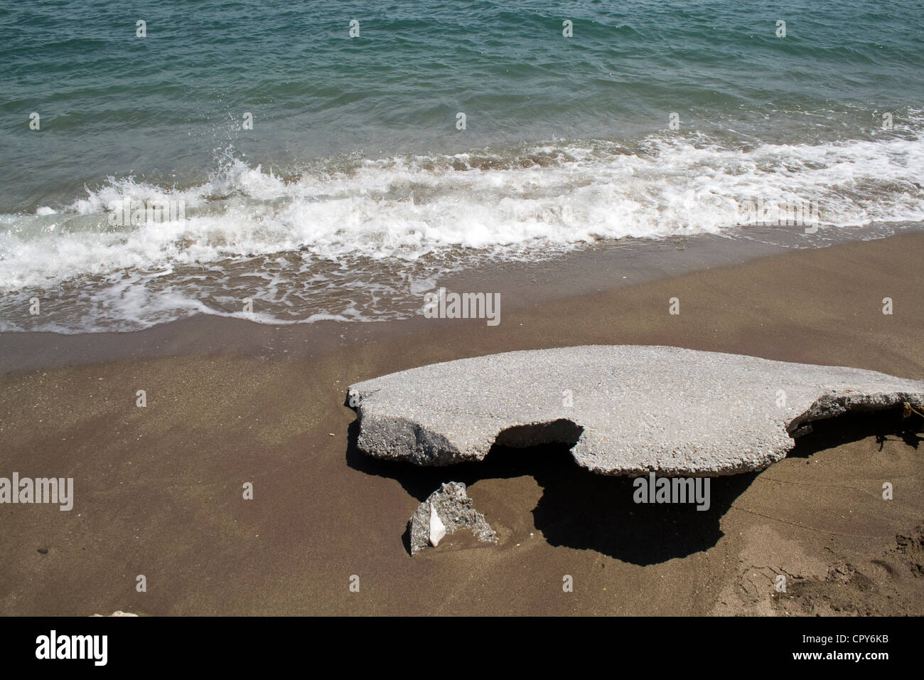 Large jagged rock on beach Stock Photo - Alamy