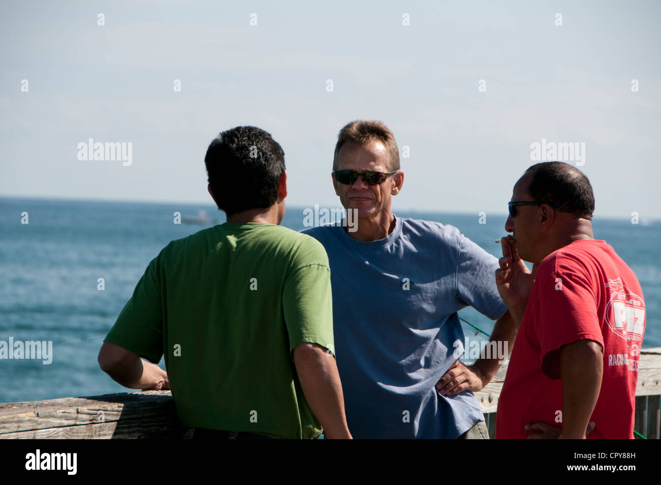 Three men talking Stock Photo - Alamy