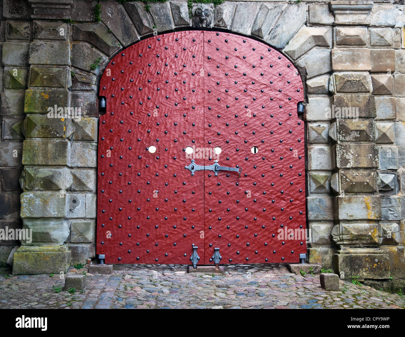 Old red gate in the wall of the castle Stock Photo - Alamy