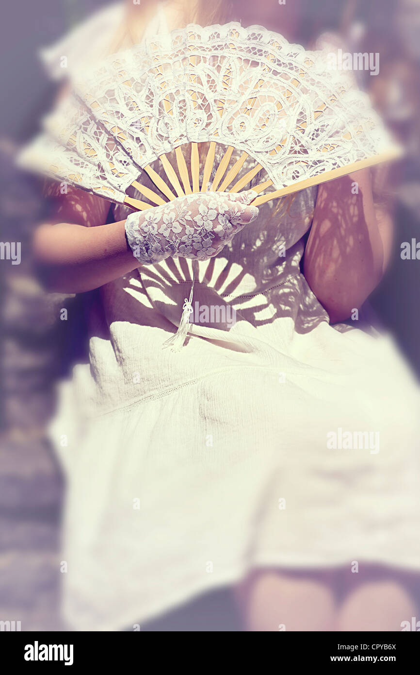 Lady with Fan and lace gloves in the sunshine Stock Photo - Alamy