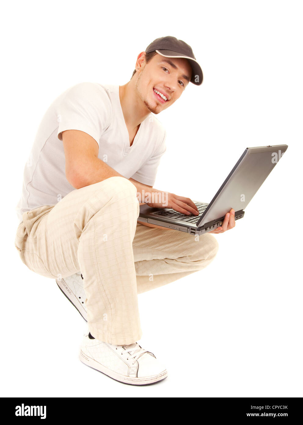 Handsome casual sitting man with laptop on white background Stock Photo ...