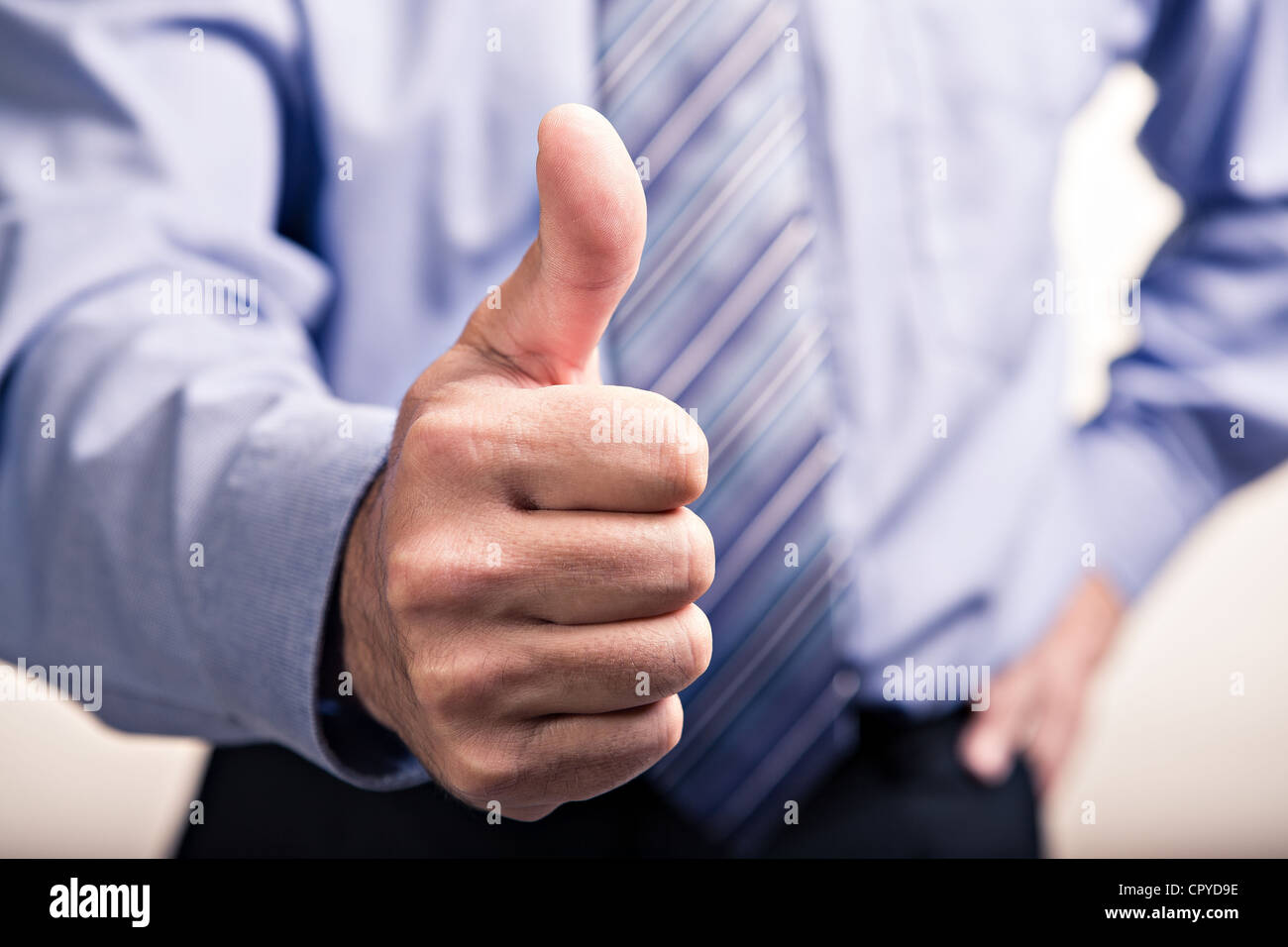 a businessman stick one's thumb in the air Stock Photo - Alamy