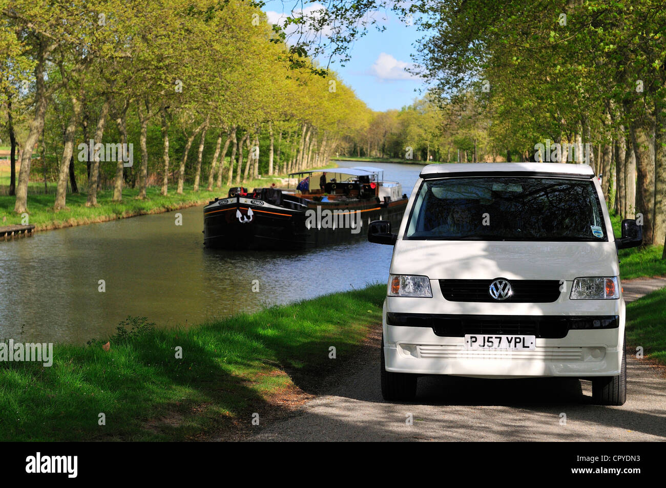 Camper van driving along canal side road on the Canal du Midi near ...