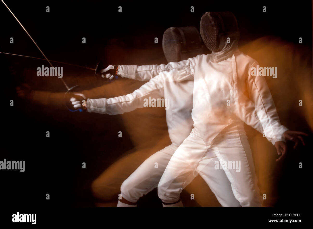 Male fencer isolated in a dark background Stock Photo - Alamy