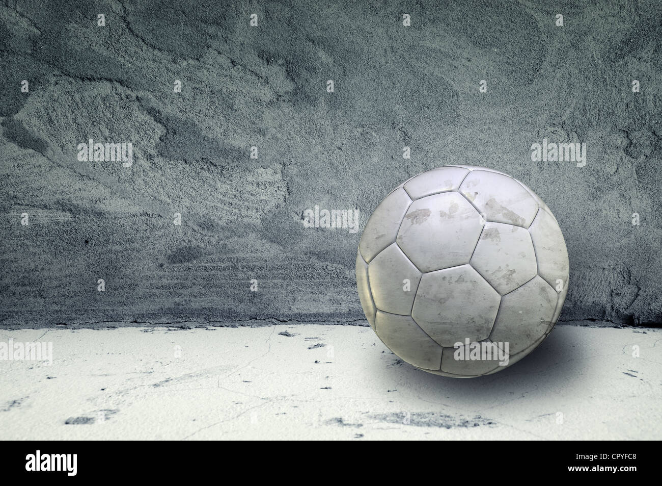 Soccer ball in an obsolete gray grunge concrete room Stock Photo - Alamy