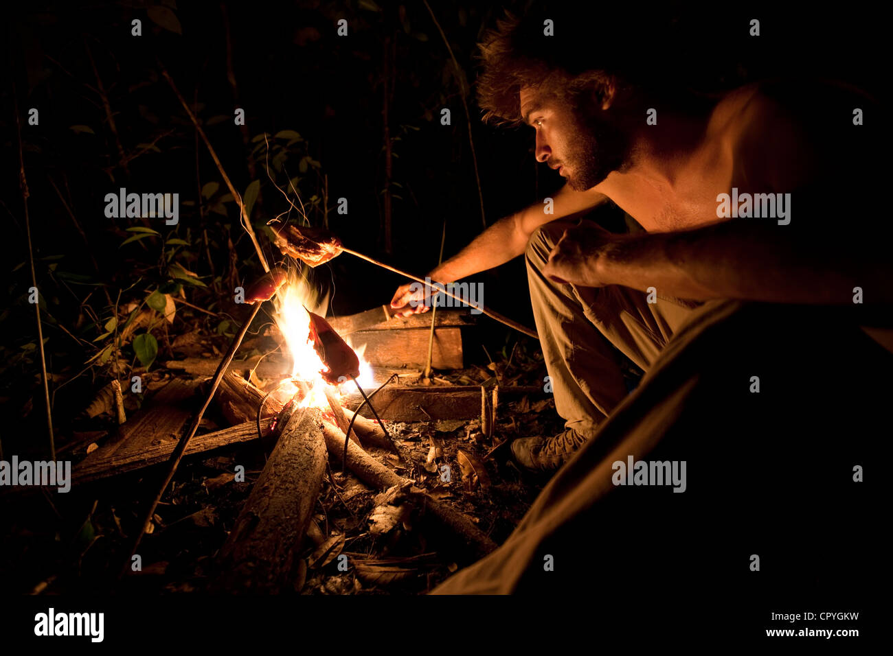 Cooking meat filets over a campfire in the Tumucumaque Wilderness Stock ...