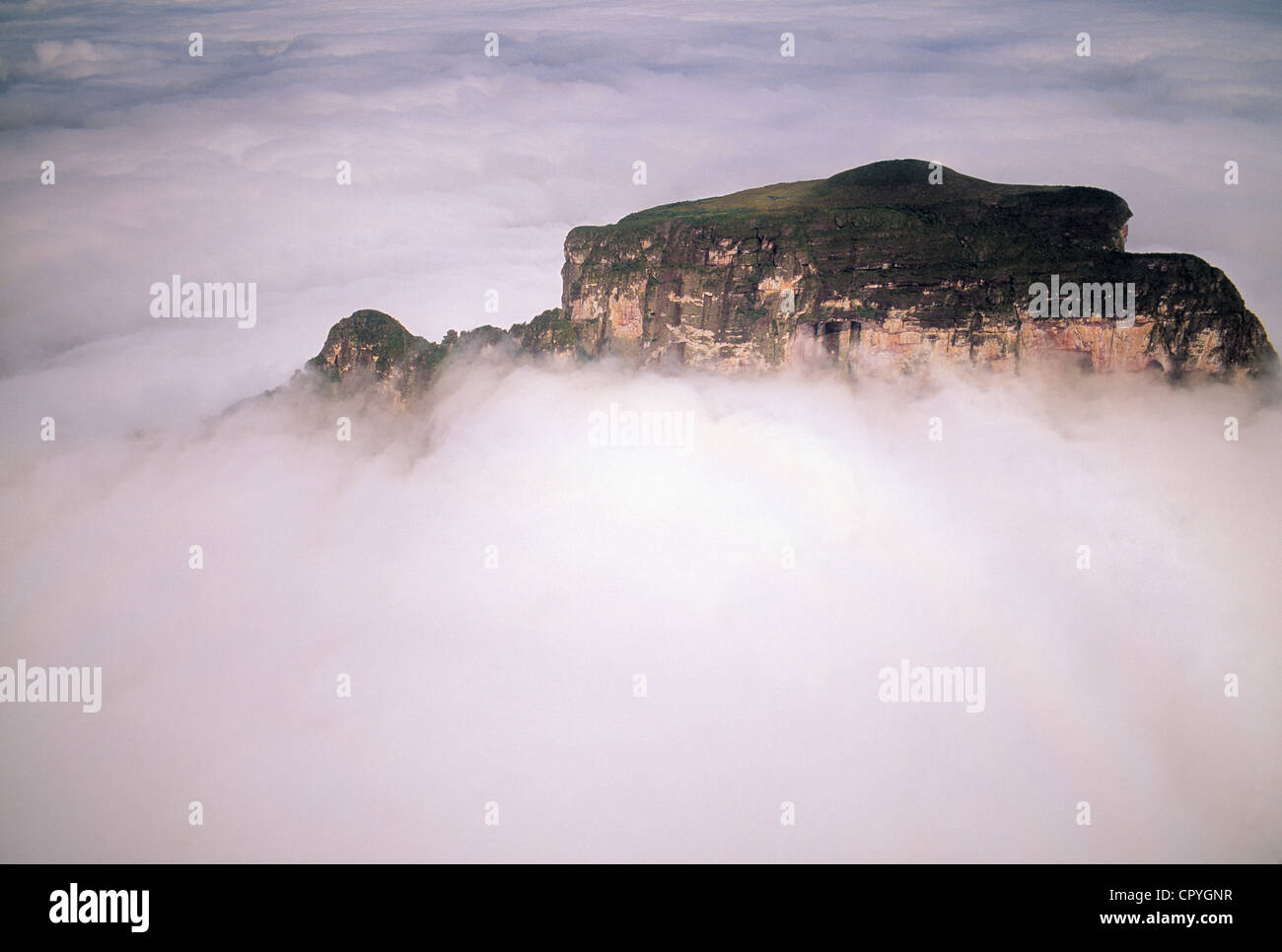 Autana mountain top peaking through cloudscape, Amazonas, Venezuela ...