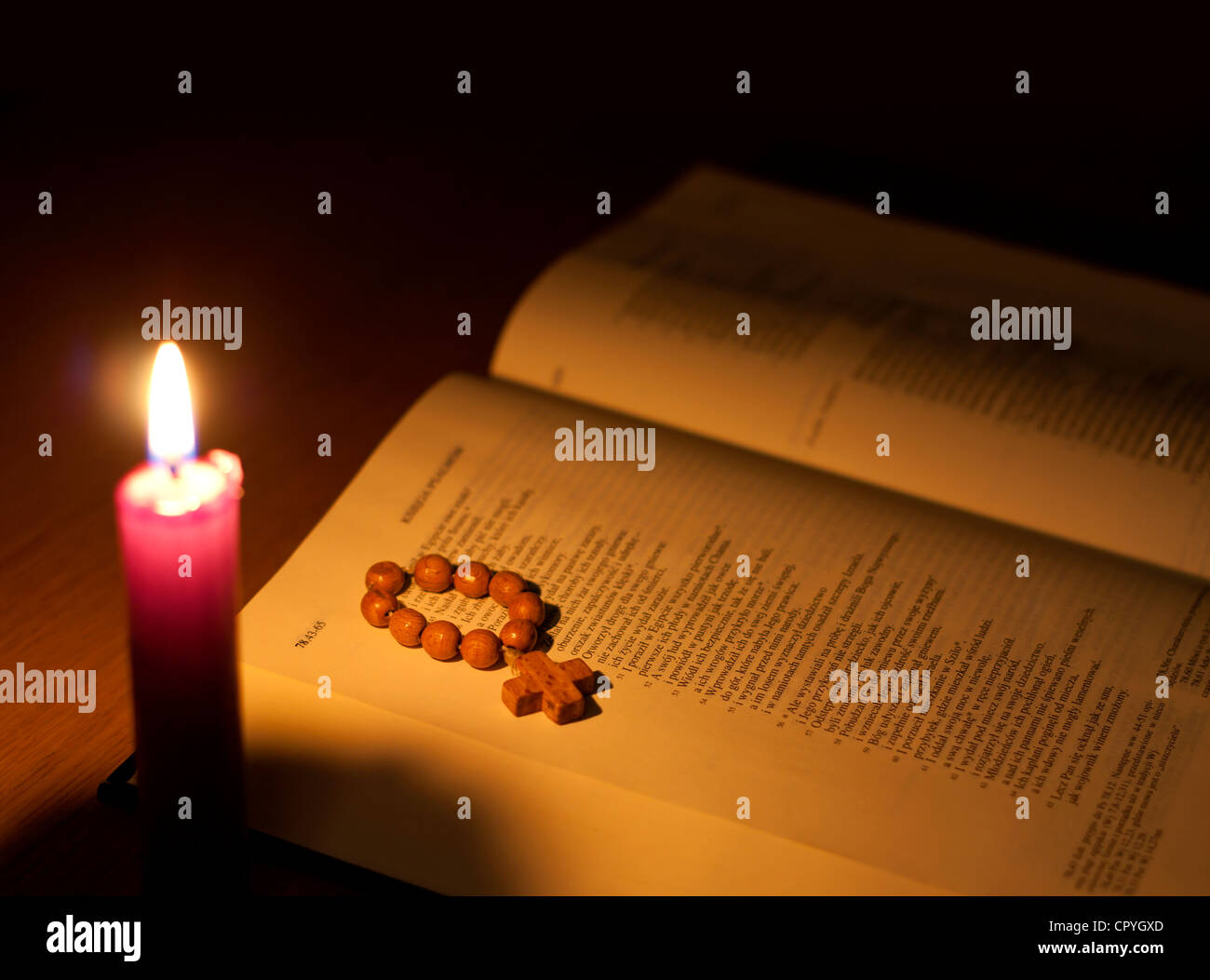 Bible and candle in the dark with candle and rosary background Stock ...