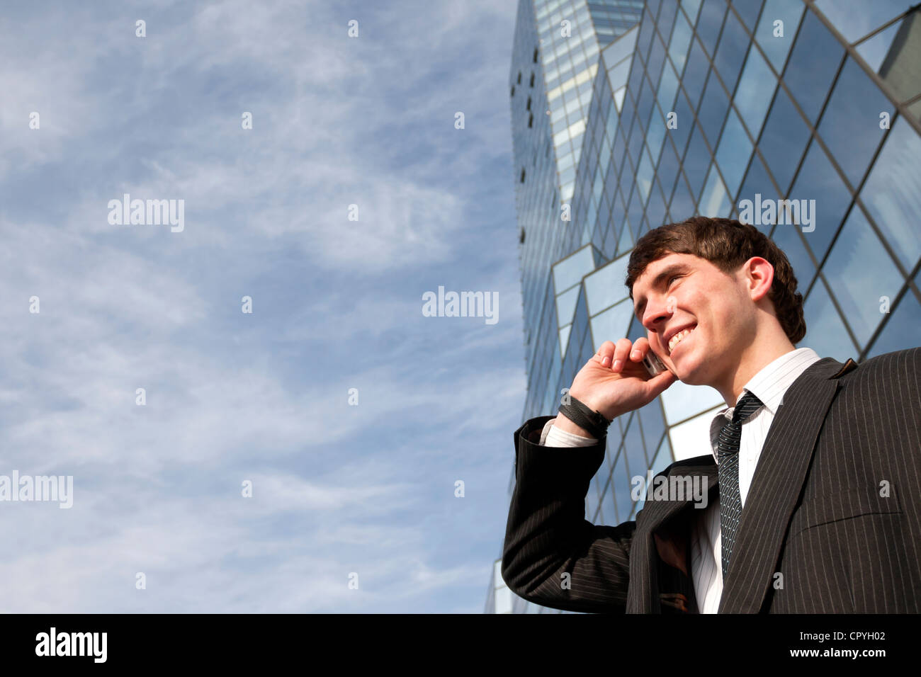 Handsome young man calling against office Stock Photo - Alamy