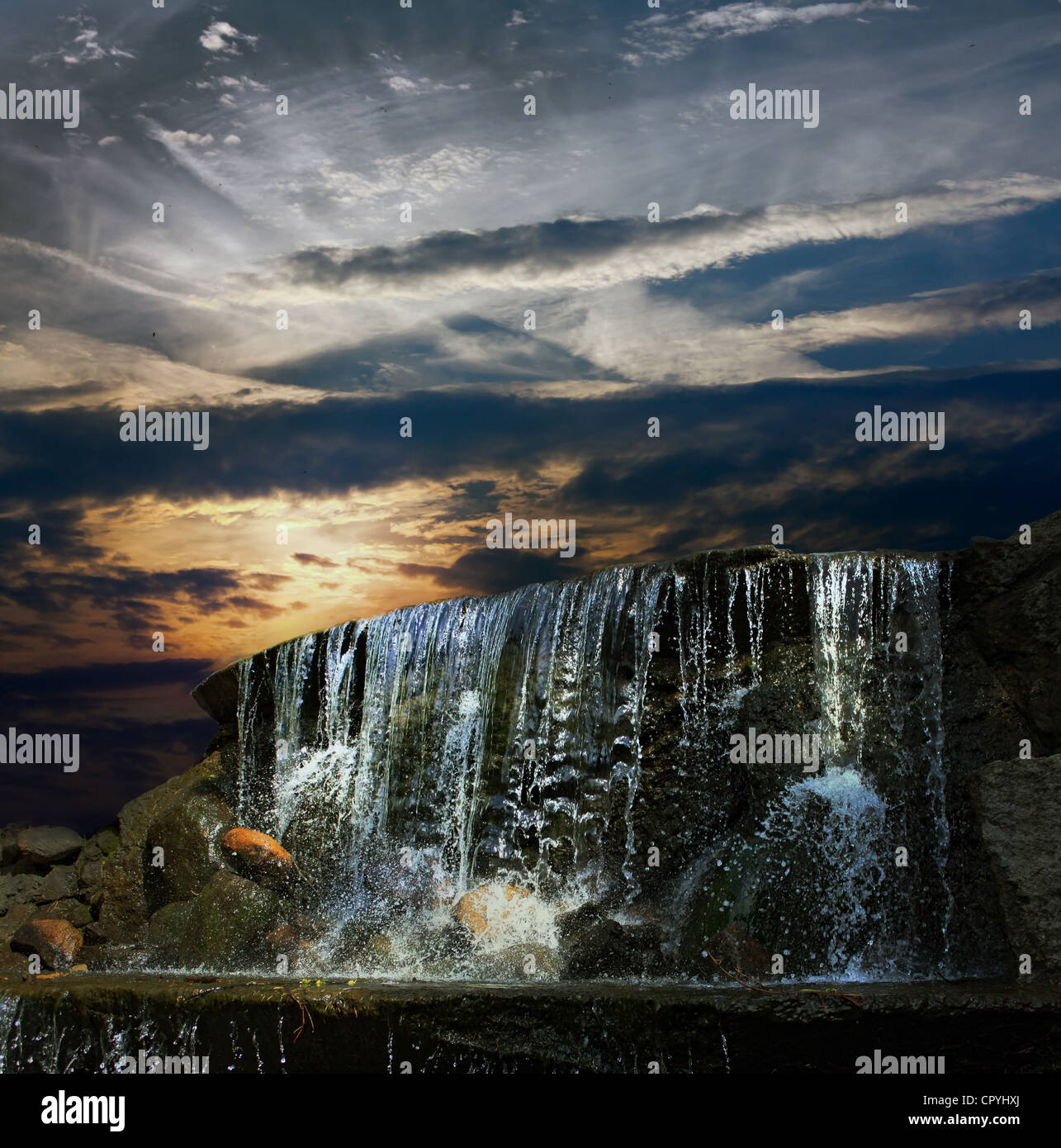 Waterfall at night at sunset background Stock Photo - Alamy