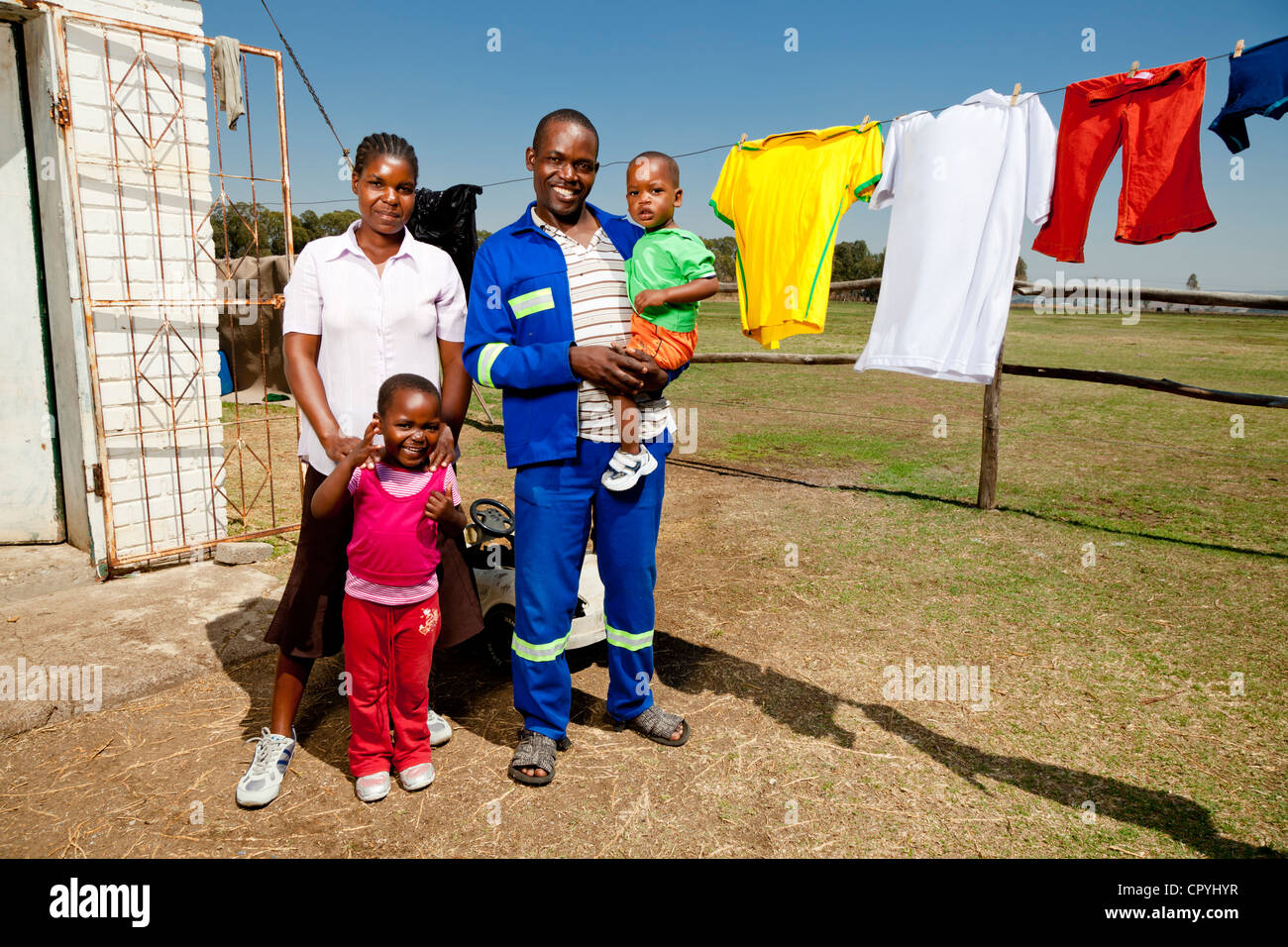 African family standing in front of their rural home, smiling Stock ...