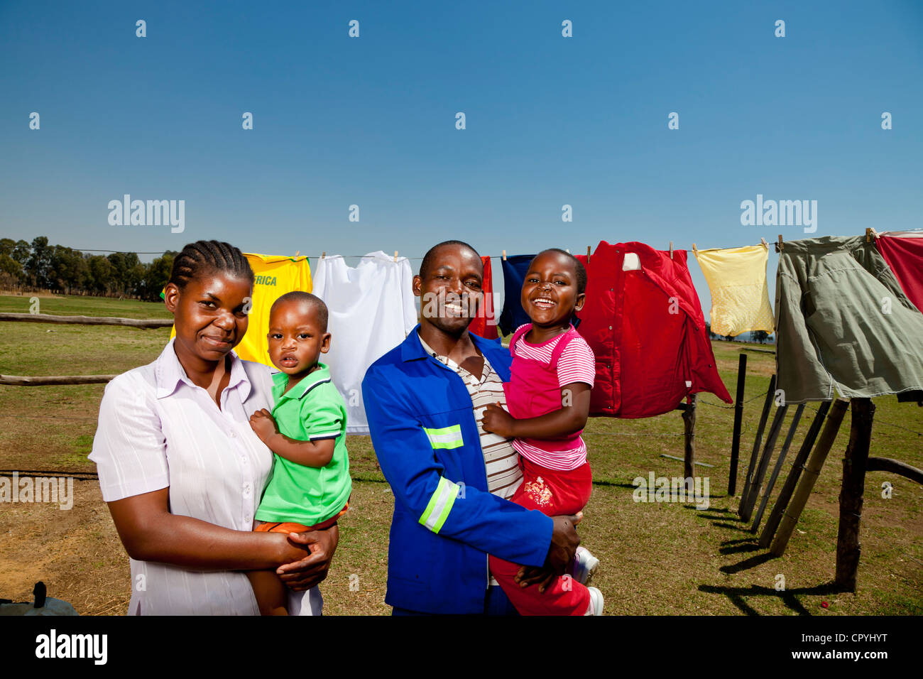 African family standing in front of their rural home, smiling Stock ...