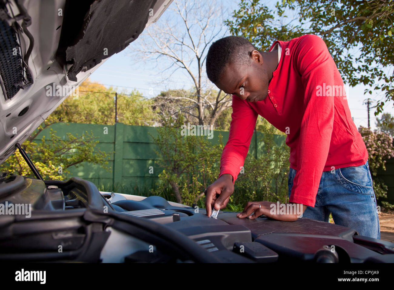 African man working on a car engine Stock Photo - Alamy