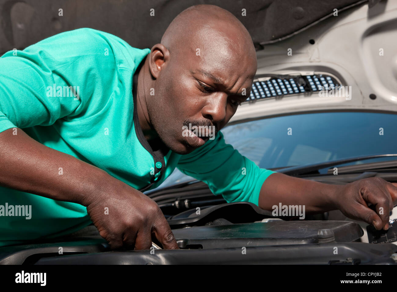 African man working on a car engine Stock Photo - Alamy