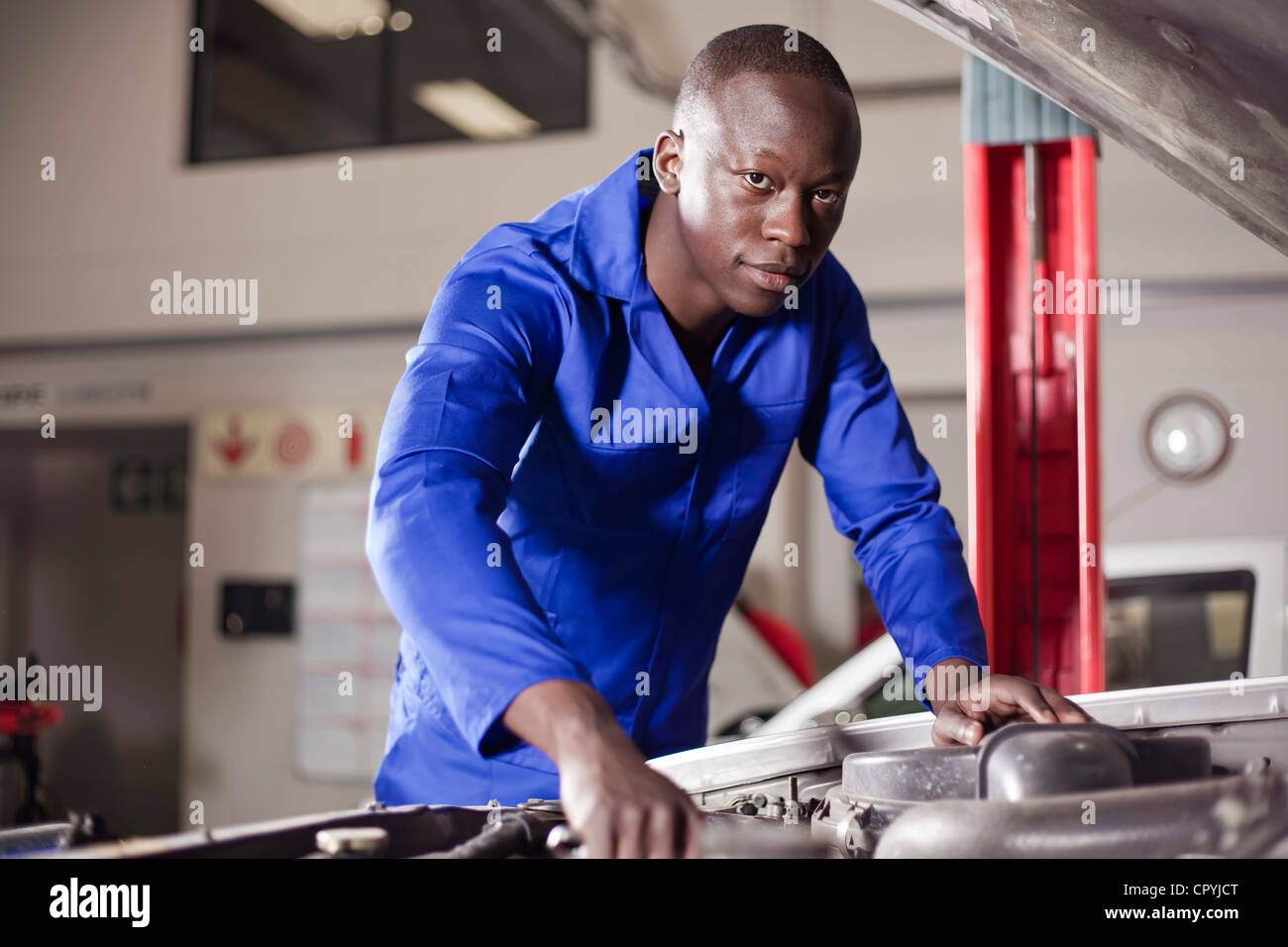 African man working on a car engine Stock Photo - Alamy