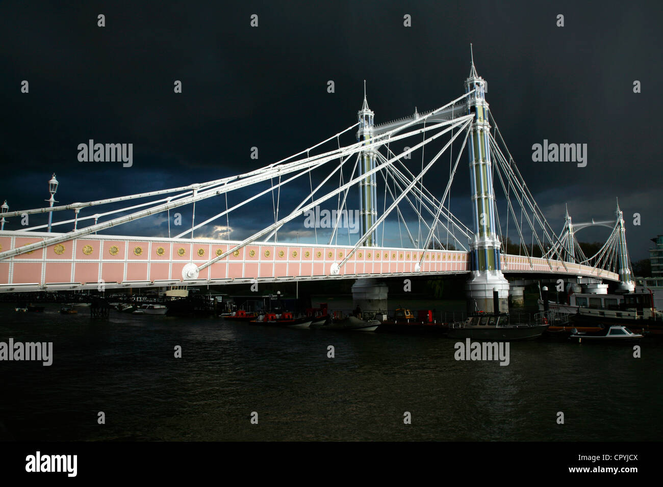 Albert Bridge lit up against a stormy sky, Battersea, London, UK Stock ...